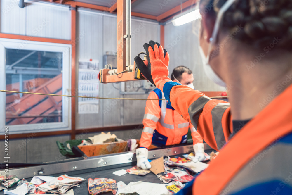 Workers in sorting room of garbage recycling facility Stock Photo ...