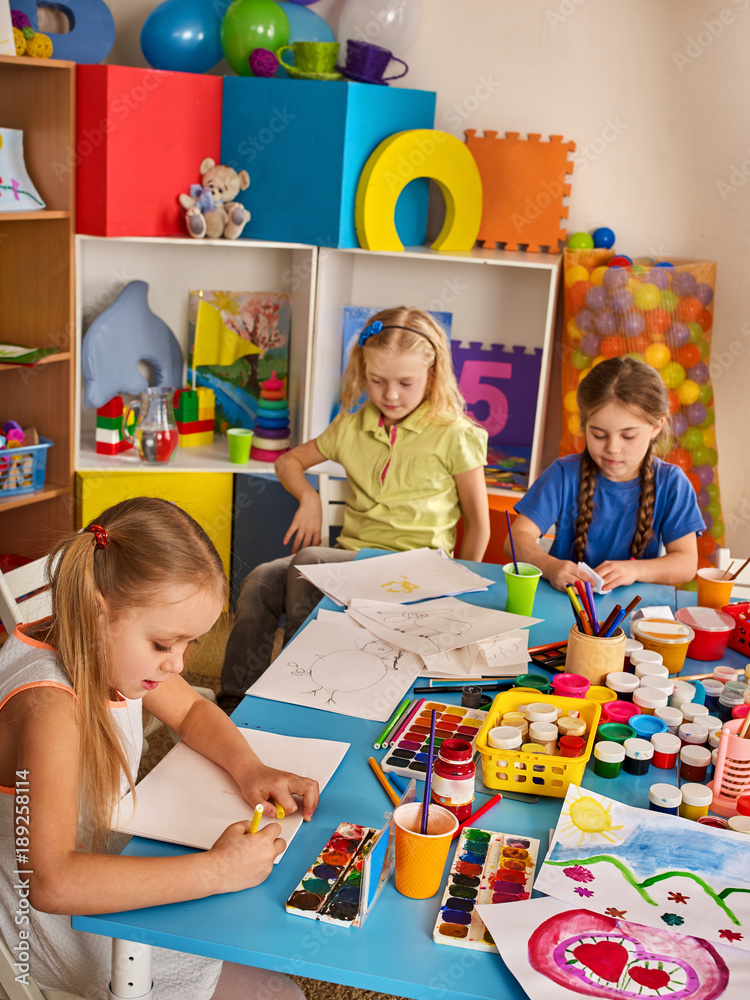 Small students painting in art school class. Child drawing by paints on ...