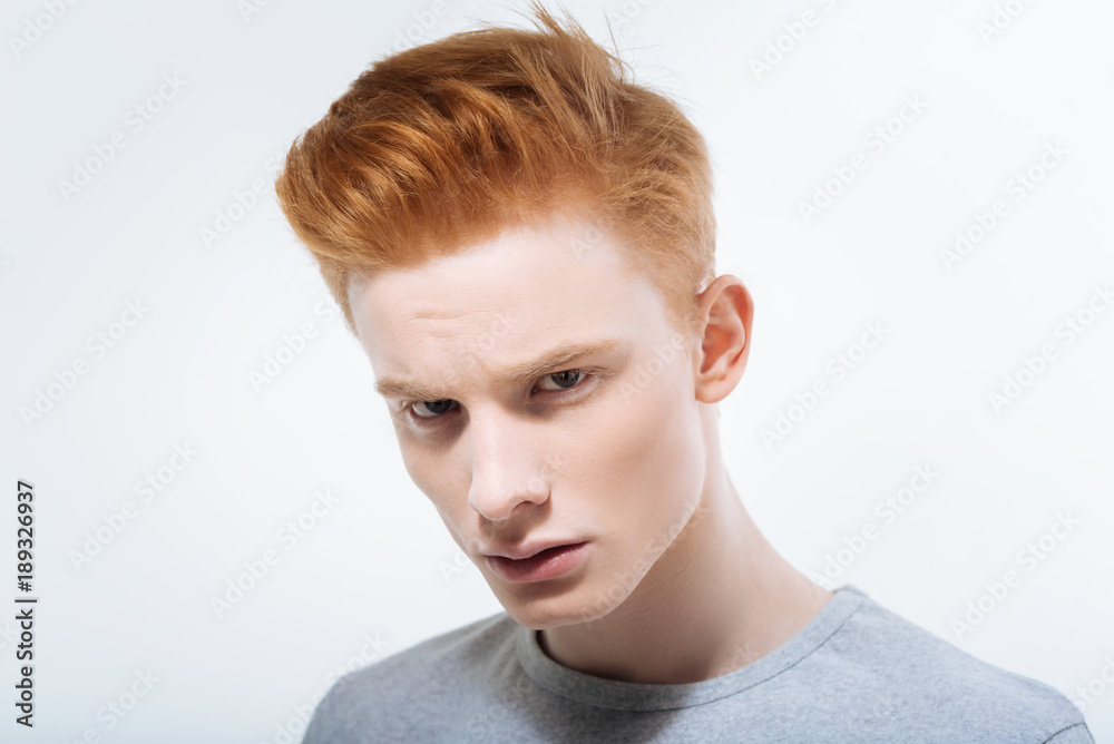 Tell me. Sad disappointed handsome guy staring at the camera and posing ...