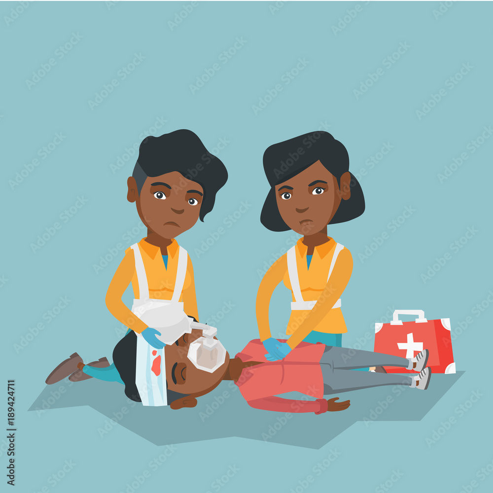 African-american paramedics doing cardiopulmonary resuscitation of a ...