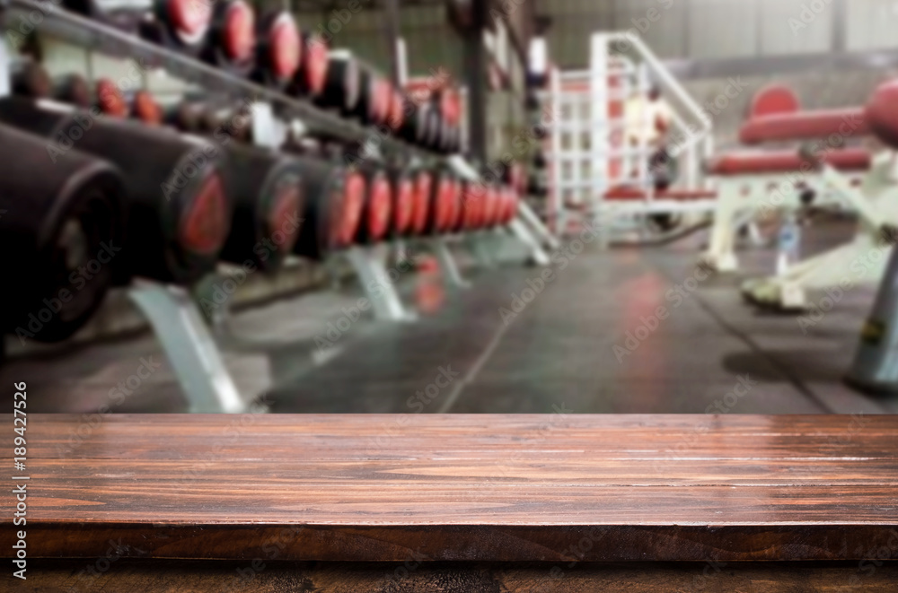 Wooden table on blurred background of fitness gym interior of modern ...
