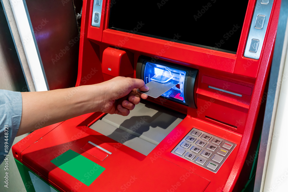 Hand of Asian woman inserting ATM card into ATM machine. Stock Photo ...