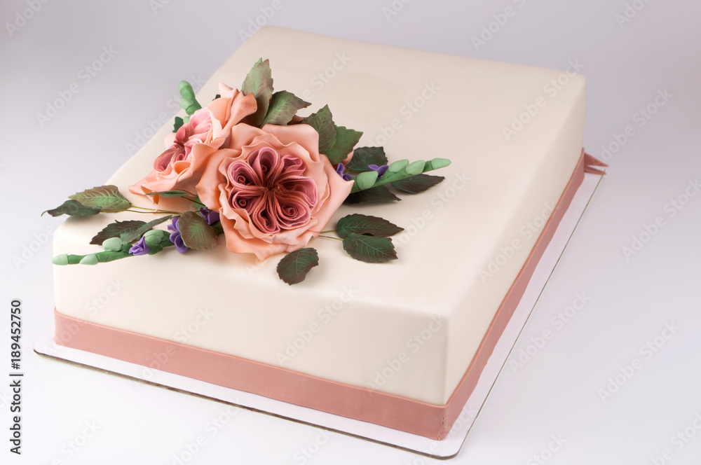 Rectangular art cake decorated with pink flowers and green leaves from ...