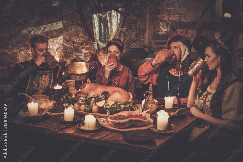 Medieval people eat and drink in ancient castle tavern Stock Photo ...