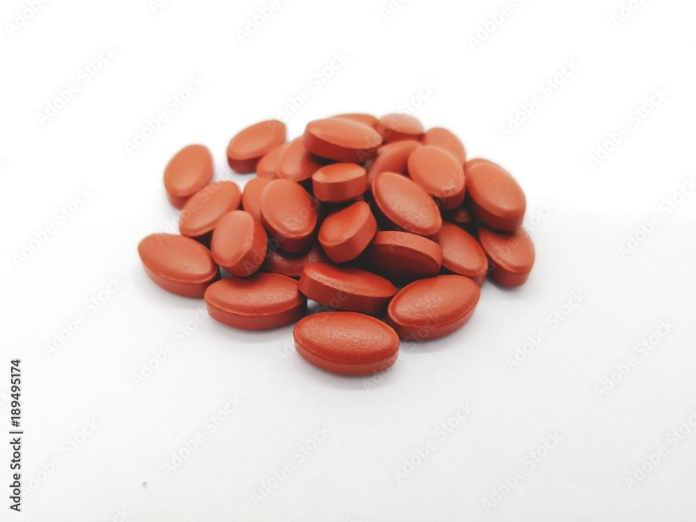 Medication concept. Many oval brown tablets of Ferrous sulfate 300 mg ...