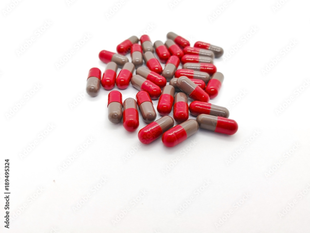 medication concept. Many grey-red capsules of Flunarizine 5 mg ...