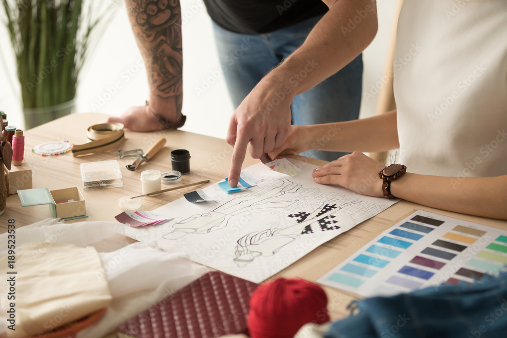 Fashion designers team choosing colors for new collection discussing ...