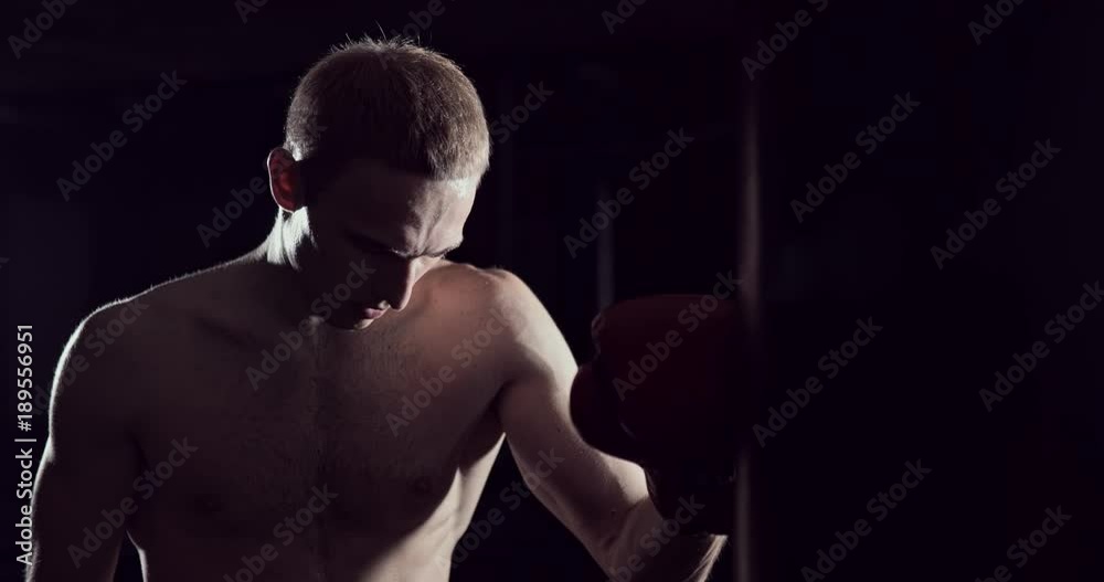 Kickboxer tired after strength training exercise at gym. Tired man ...