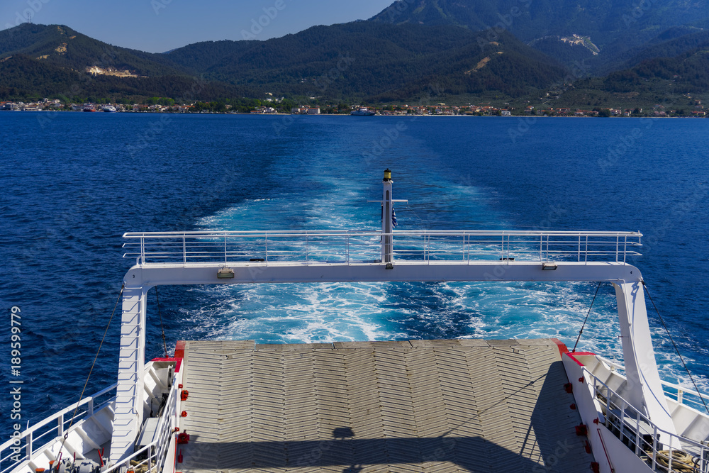 Cart Ferry sailing away from green island. Vehicle ferryboat across ...