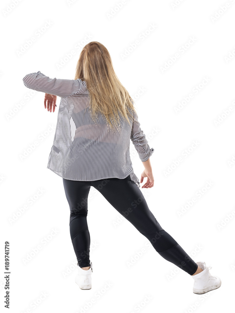 Back view of elegant graceful long hair blonde woman dancing slowly in ...