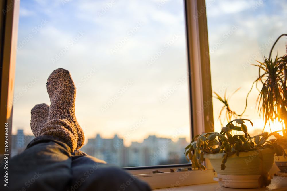 Men's feet in socks on relaxation window Stock Photo | Adobe Stock