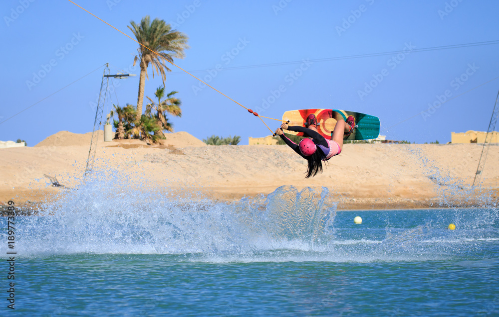 Wake boarding female sportsman girl jumping high wake boarding raley ...