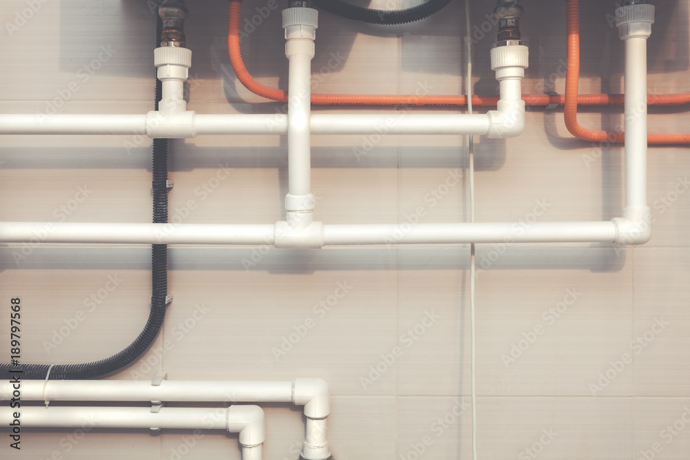 White plastic water pipes of plumbing system with Y-branch fitting ...