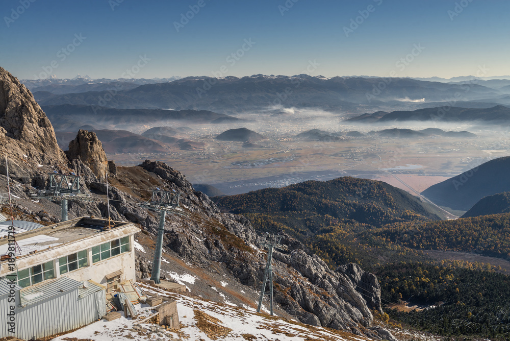 Bird eye view seeing cable car station with foggy mountain range and ...