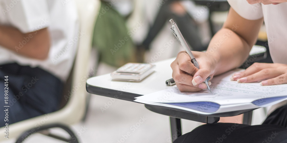 Blur school background university students writing answer doing exam in ...