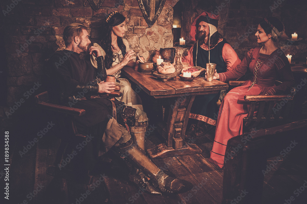 Medieval people eat and drink in ancient castle tavern Stock Photo ...
