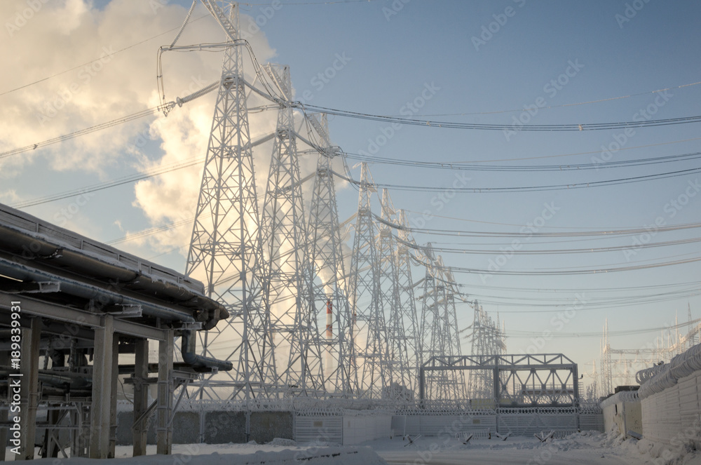 High voltage power lines in the winter. Thermal power plant with smoke ...
