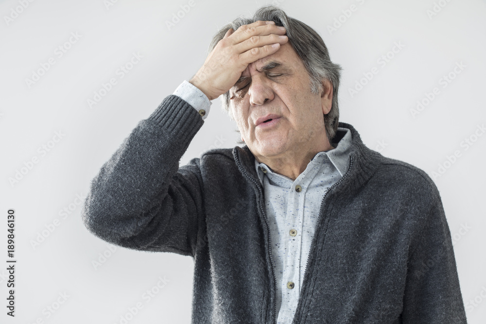 Old man keeps hand on forehead Stock Photo | Adobe Stock