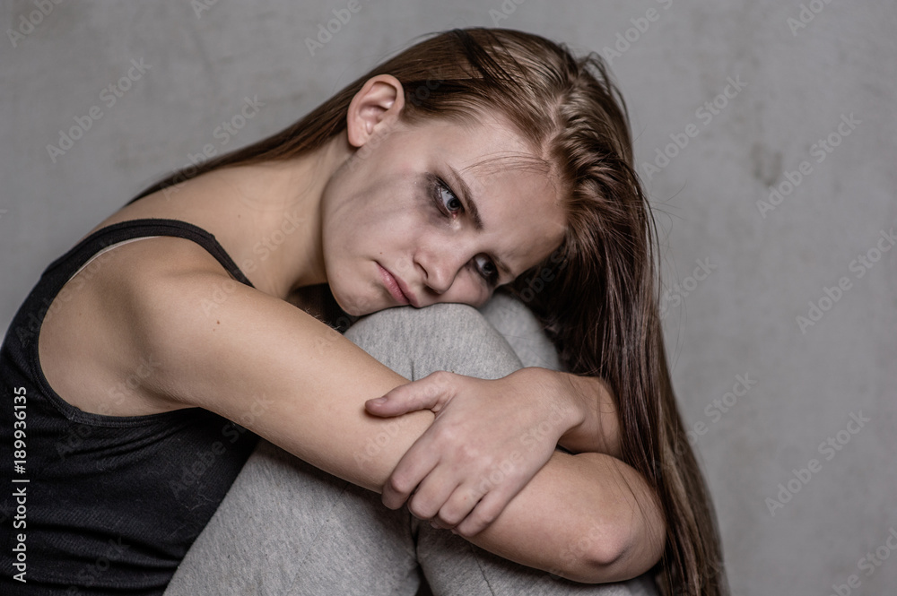 sad teen girl hug her knee and cry Stock Photo | Adobe Stock