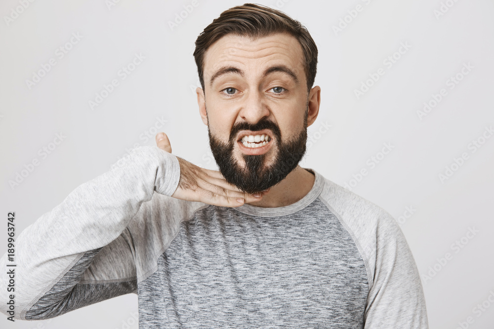 Foto de Mad bearded guy showing fed up gesture by cutting neck with ...