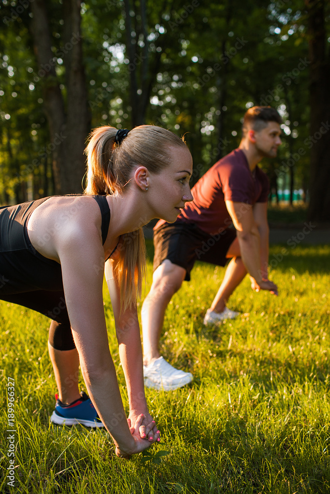 paired workout outdoor fitness sport exercises concept. work of trainer ...