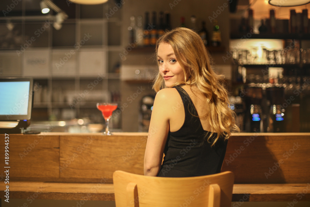 Charming woman sitting at the counter Stock-Foto | Adobe Stock