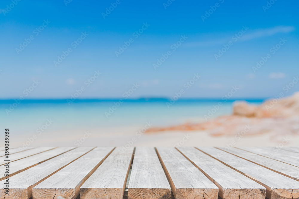Empty wood table top and blurred restaurant summer beach with sea and ...
