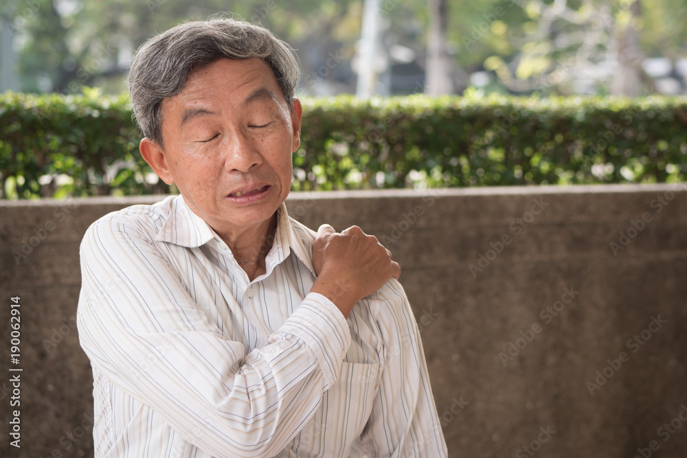 senior man suffering from elbow joint pain or injury or stiffness, old ...