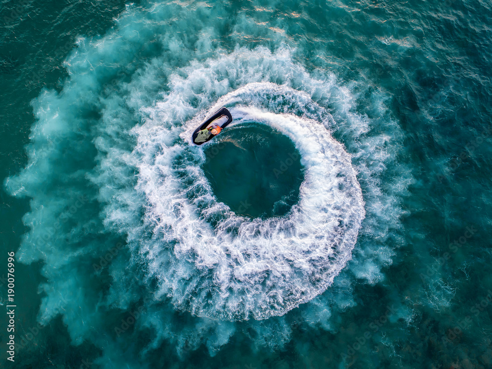 People are playing a jet ski in the sea.Aerial view. Top view.amazing ...