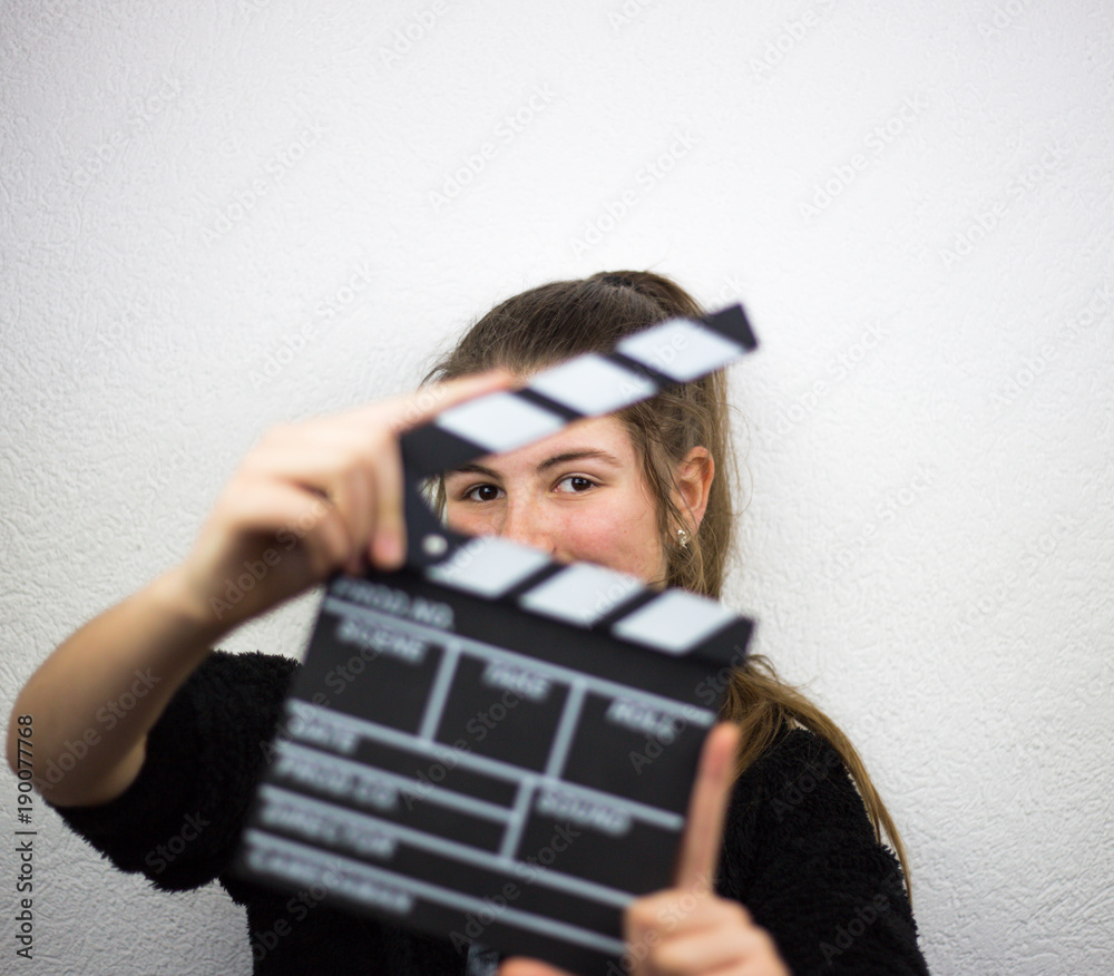Start a movie scene with a movie clapper. Black and white in the studio ...