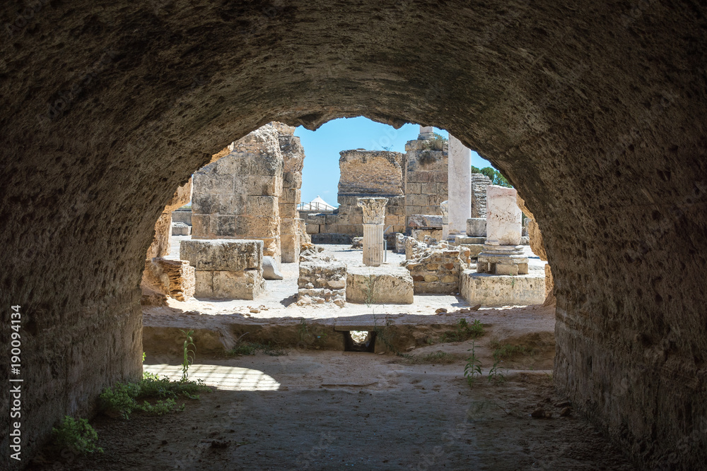 View through arch to archaeological site. Ancient columns of marble and ...