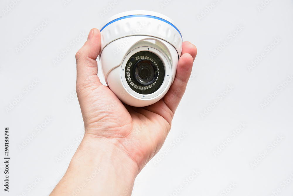 Dome round surveillance camera in male hand Stock Photo | Adobe Stock