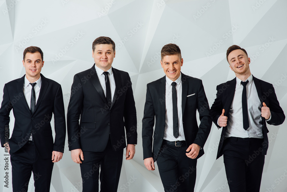 Group of four men in suits white background Stock Photo | Adobe Stock
