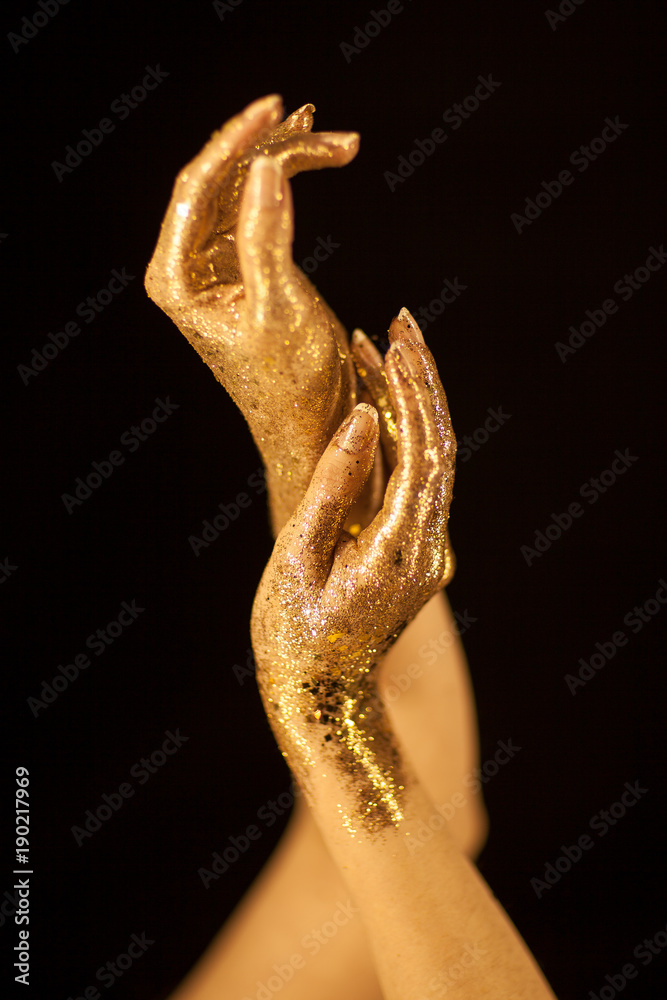 Beautiful woman hands gold, golden hands, glitter posing like ballet ...