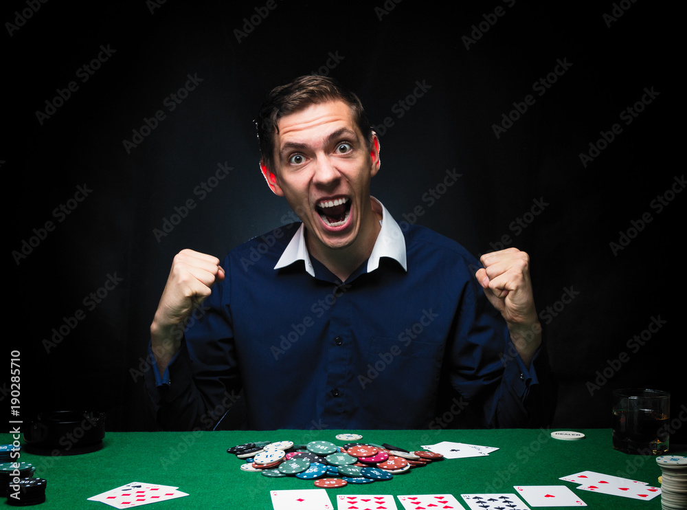 Man is playing poker. Emotional card player win in game, man very happy ...
