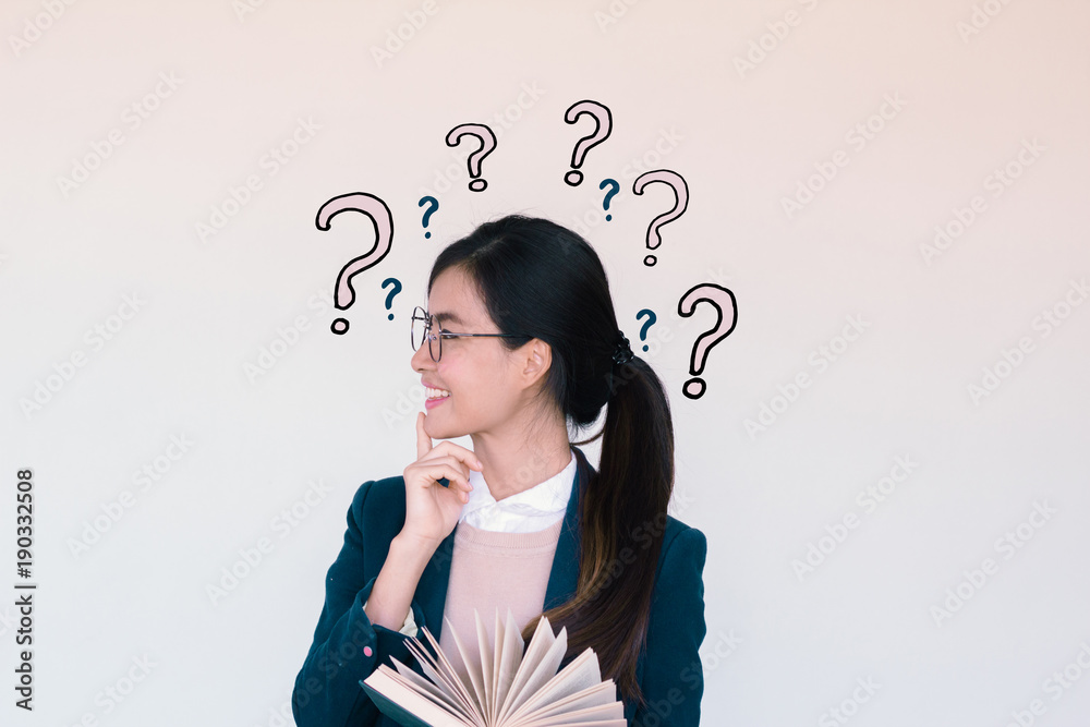 Young asian Student woman holding book and question marks doodles at ...