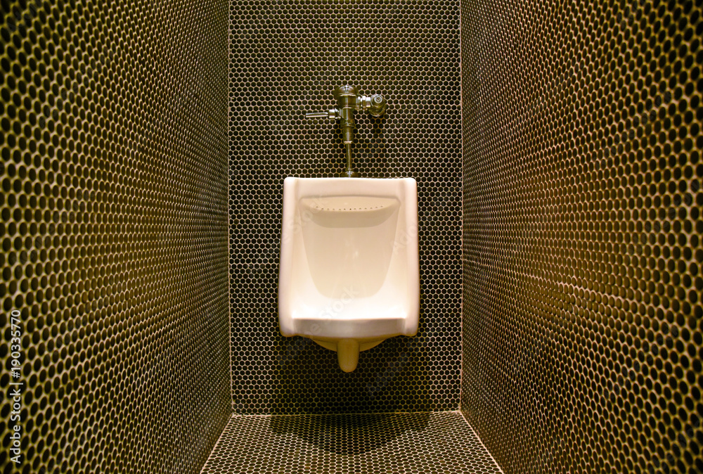Urinal with modern textured walls and floor Stock Photo | Adobe Stock