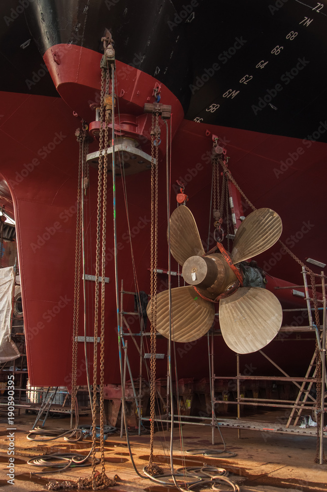 Ship's hull, rudder and propeller under maintenace in dry-dock in ...