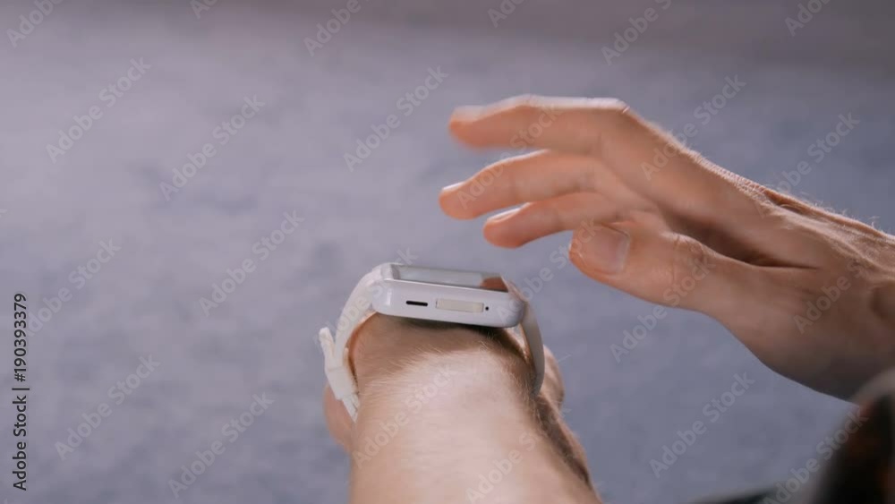 Man using wearable smartwatch computer device in the room - scrolling ...