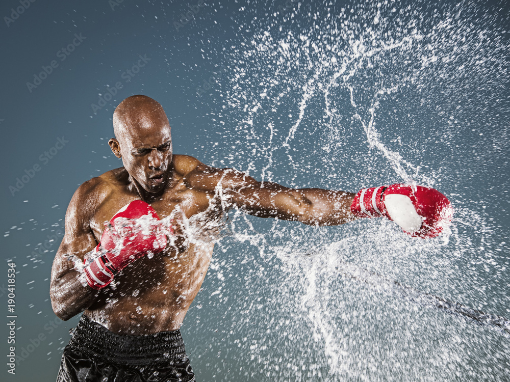 Water splashing on black boxer punching Stock Photo | Adobe Stock