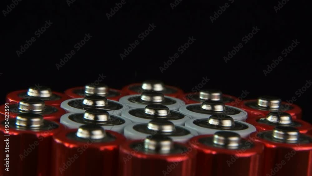 A pack of AA batteries, extremely close-up, slow rotation. Batteries ...