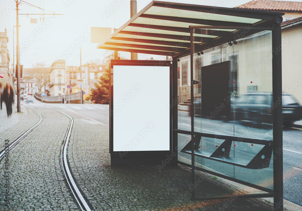 Glass and metal tram stop with railway track near and blank white mock ...