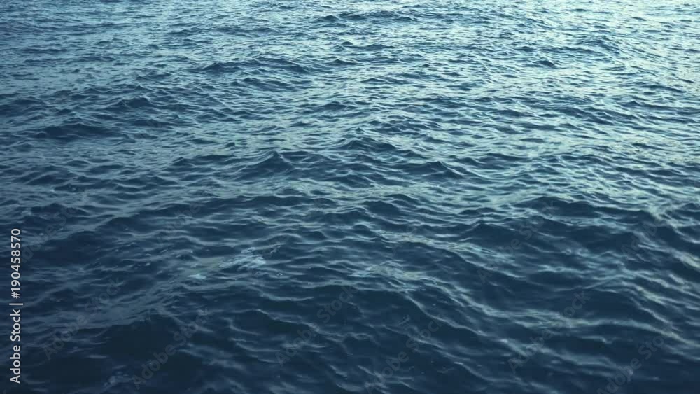 Texture of the surface of the dark surface of the sea. Small waves on ...