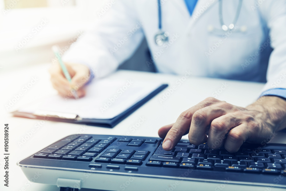 doctor working on computer in clinic office Stock Photo | Adobe Stock