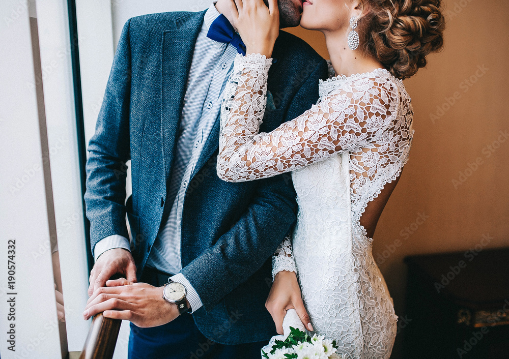 wedding couple, the bride holding the groom by the shoulder and a ...