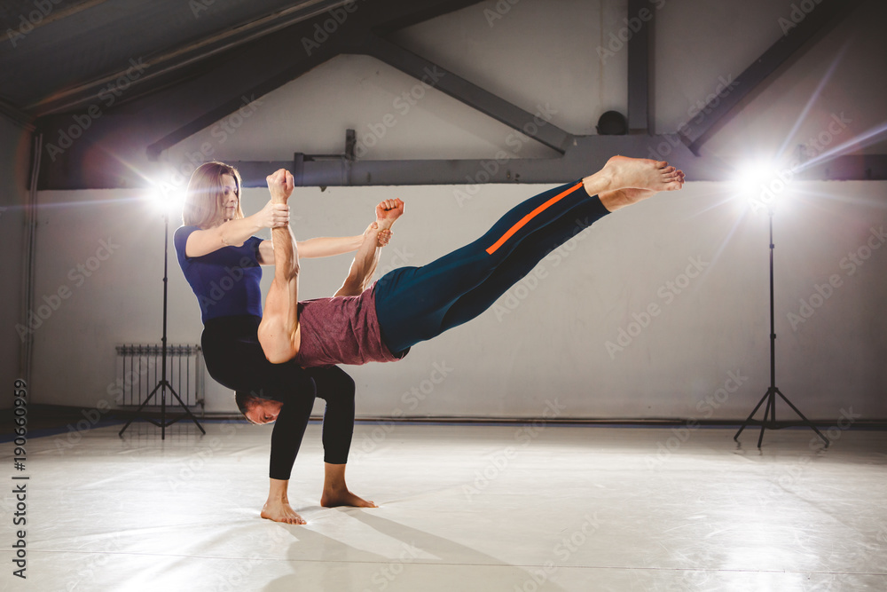 The theme of Acroyoga and Yoga Poses. Acroyogis practicing. with the ...