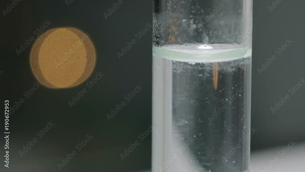 Chemical reaction in a glass vial. Determination of acidity. Reaction ...