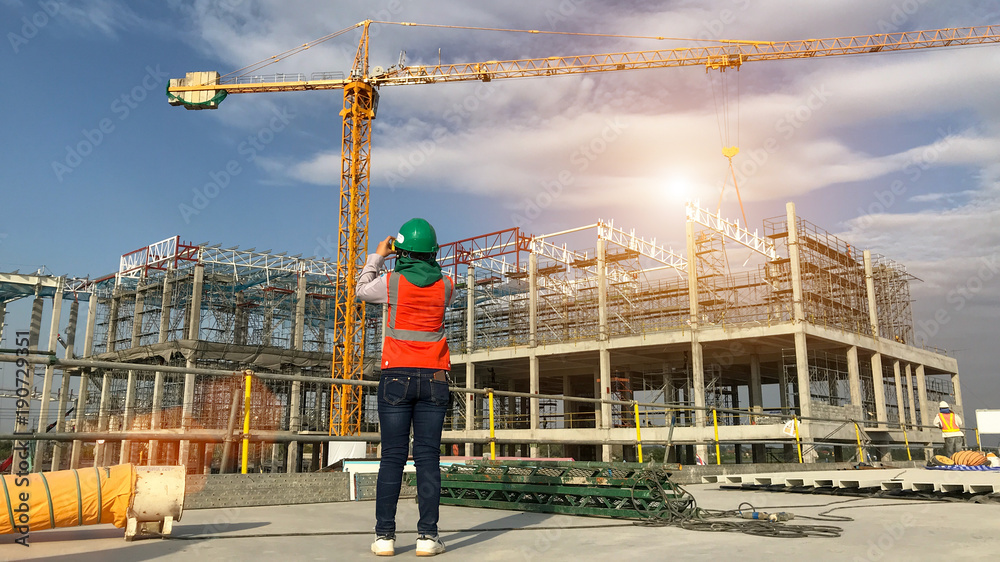 Construction engineers supervising progress of construction project ...