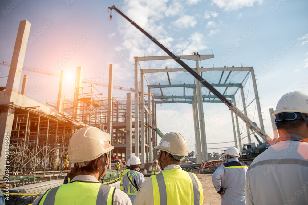 Construction engineers supervising progress of construction project ...