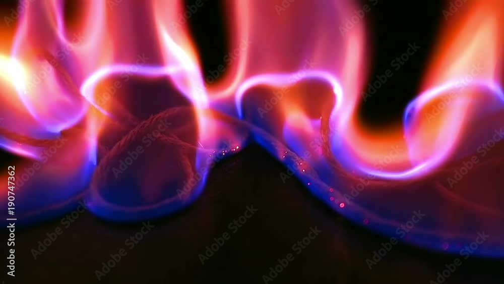 Blue and red flame background in dark. Burning liquid looks like a ...